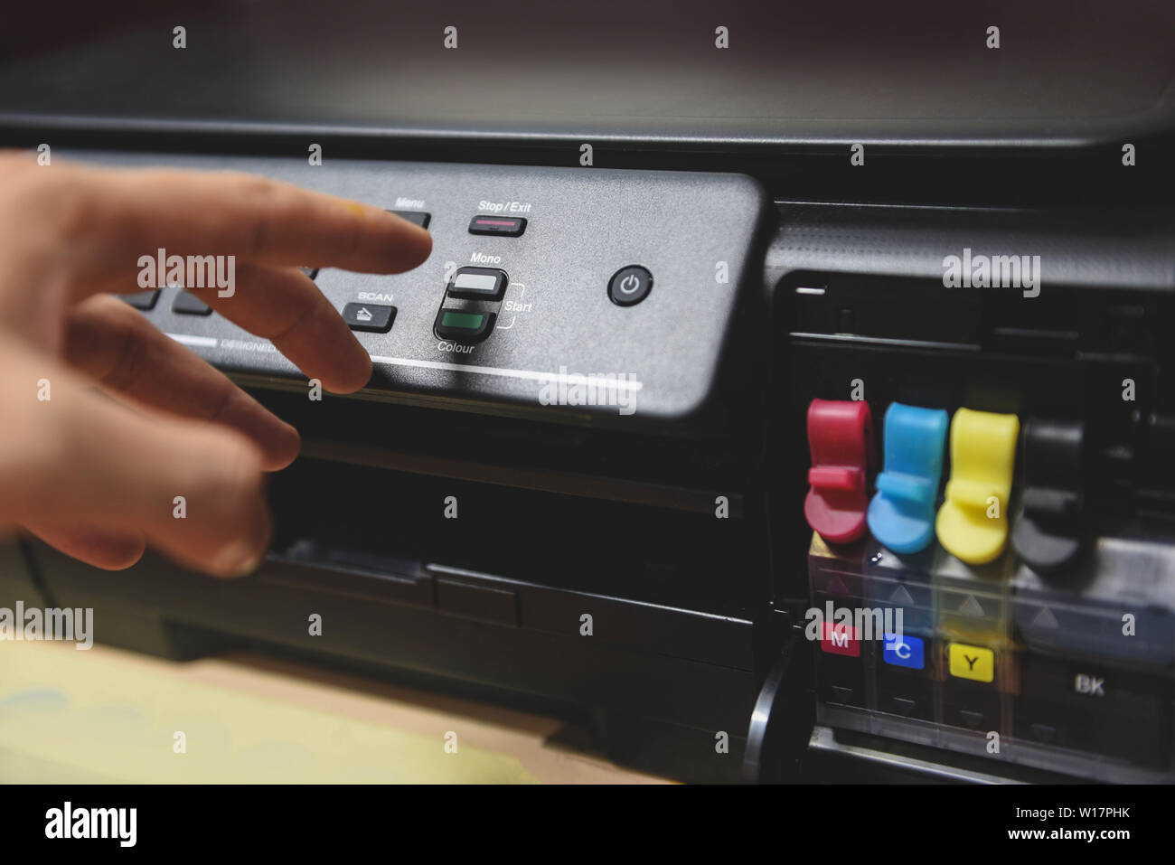 Copier concept / Business man hand press button on panel on printer ink ...