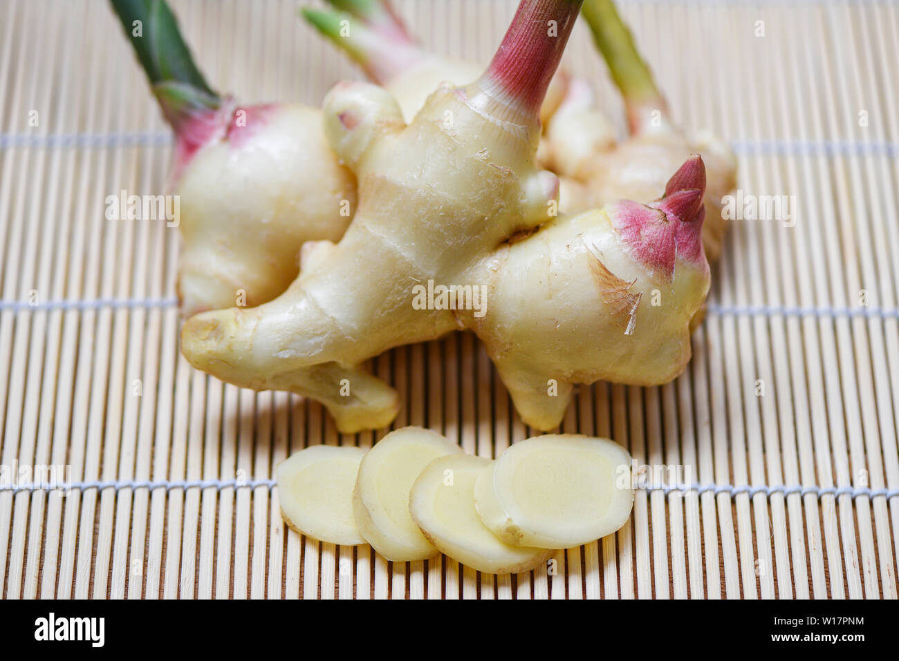 Ginger slice on wooden background / Fresh young ginger for herb ...
