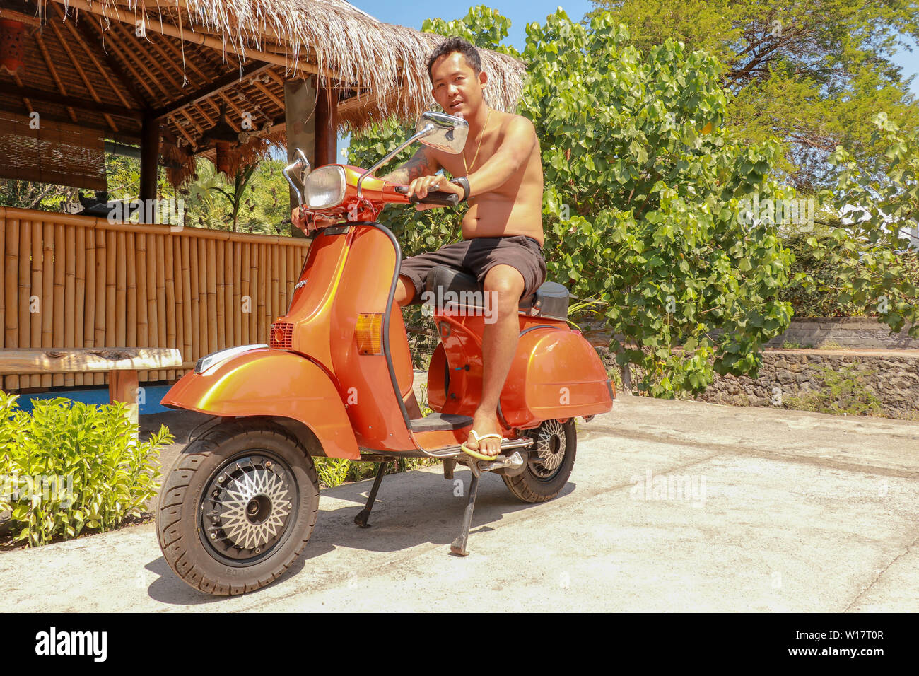 Happy man riding a motorscooter hi-res stock photography and images - Alamy