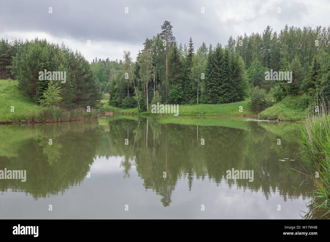 City Amatciems, Latvian republic. A clean lake and surrounded by green ...