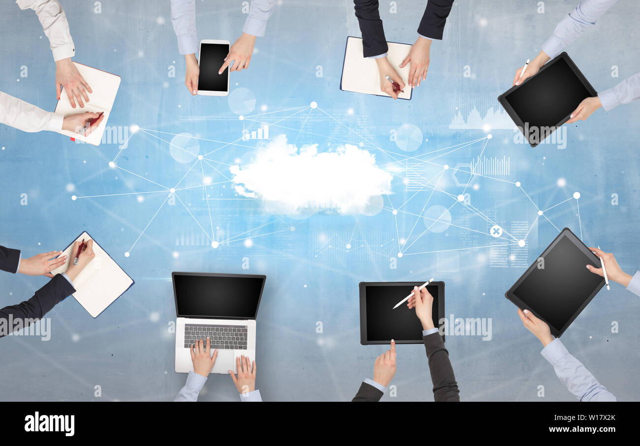 Group of people with devices in hands working on reports with online ...