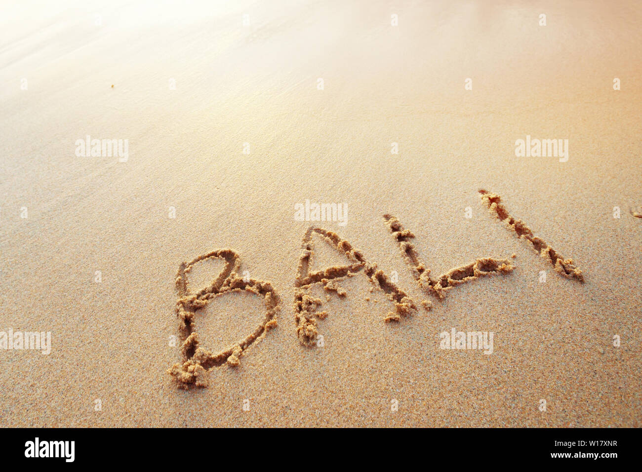 Bali letters handwritten in sand on beach Stock Photo - Alamy
