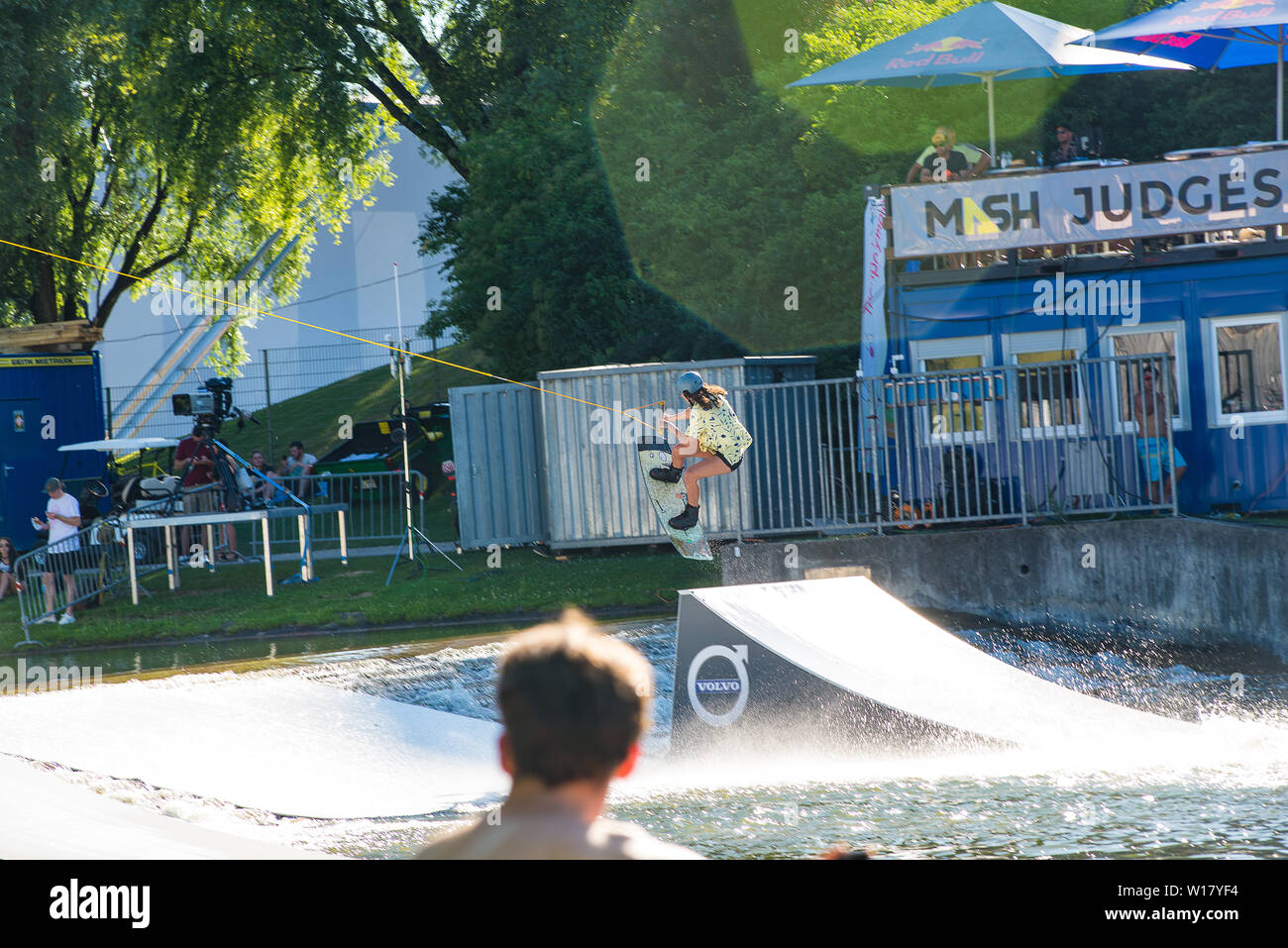 A wakeboarder jumps off a ramp during her performance Stock Photo - Alamy
