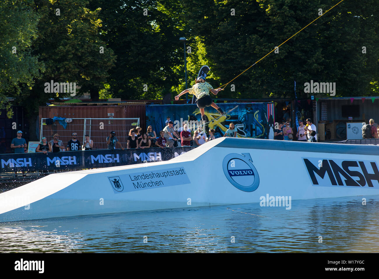 A wakeboarder jumps off a ramp during her performance Stock Photo - Alamy