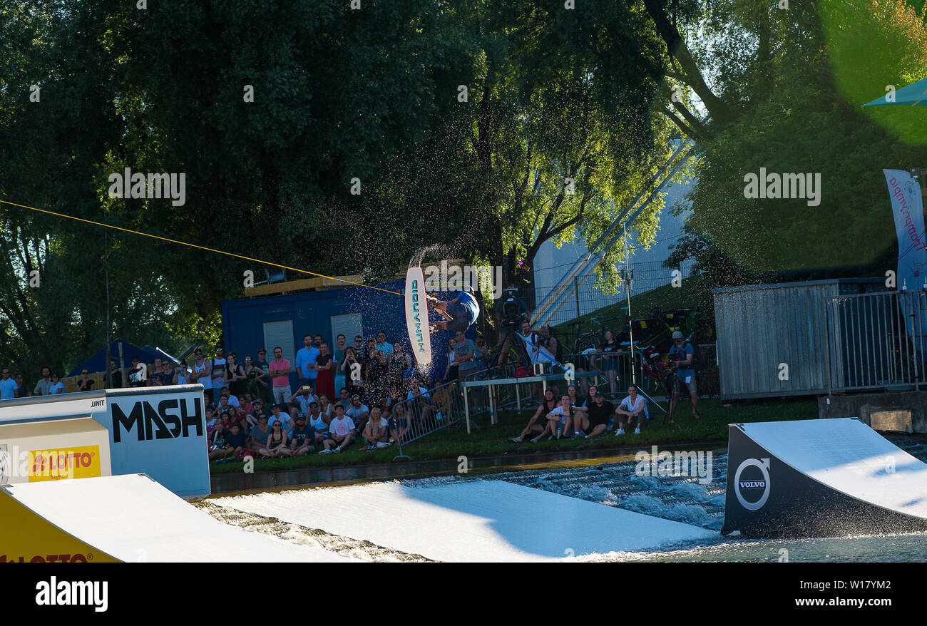 A wakeboarder jumps off a ramp during his performance Stock Photo - Alamy