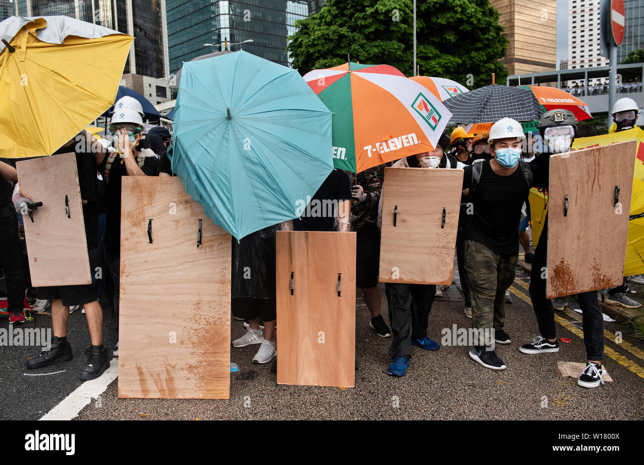 Anti government protesters using umbrellas and wooden homemade shield ...