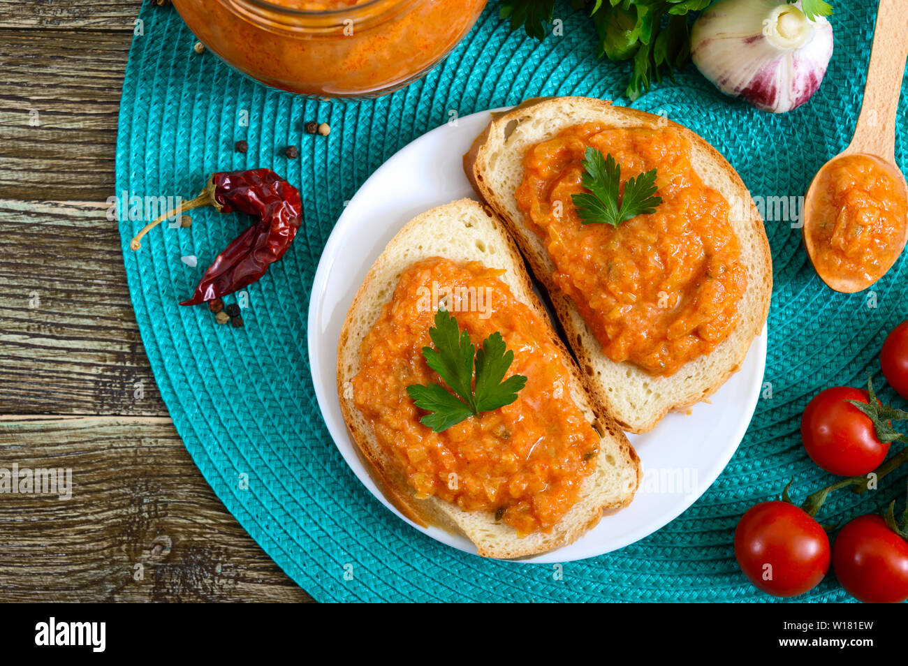 Delicious squash caviar in a jar and spread on slices of white bread on ...