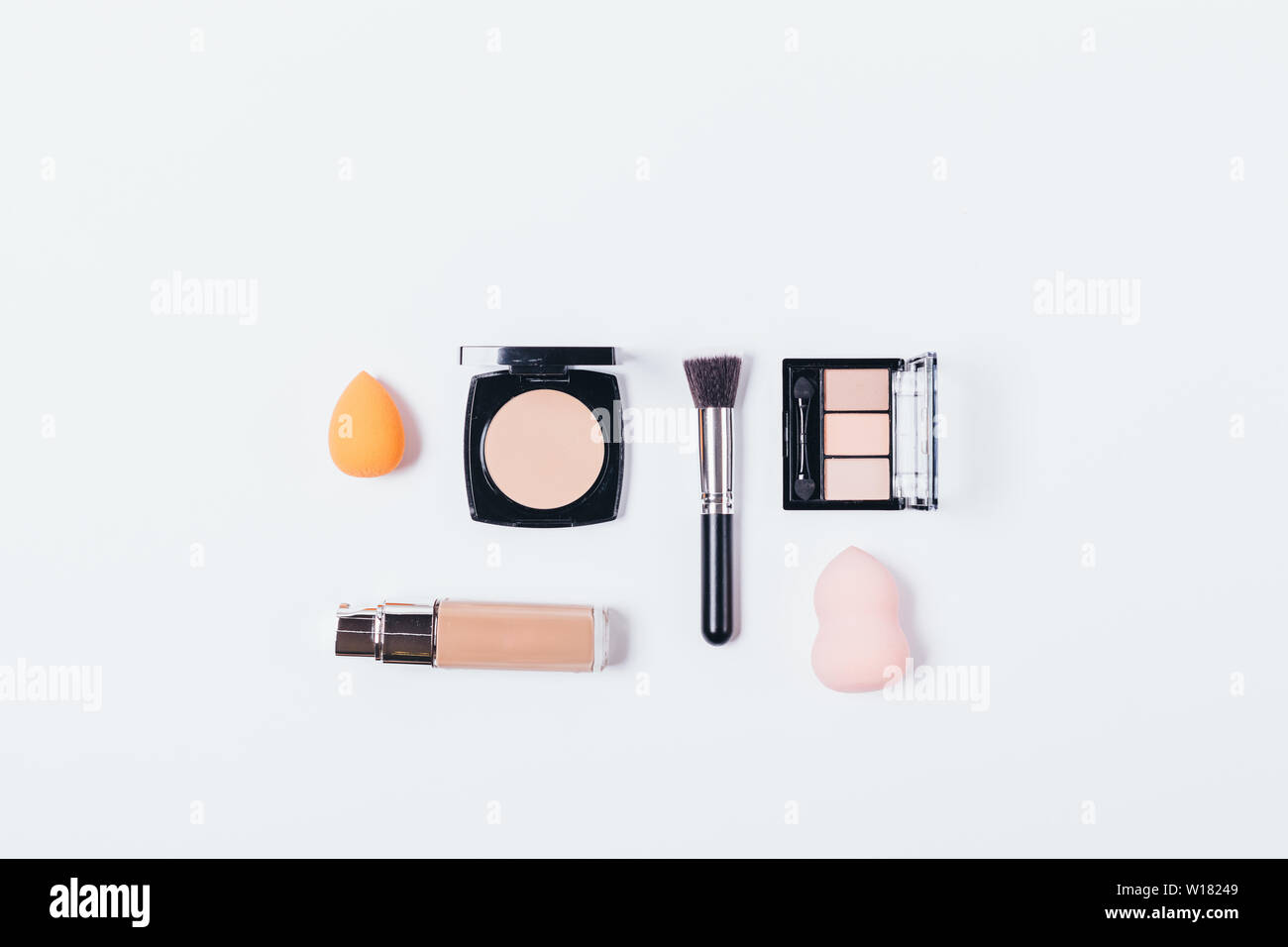 Flat lay arrangement of complexion makeup products and accessories for ...