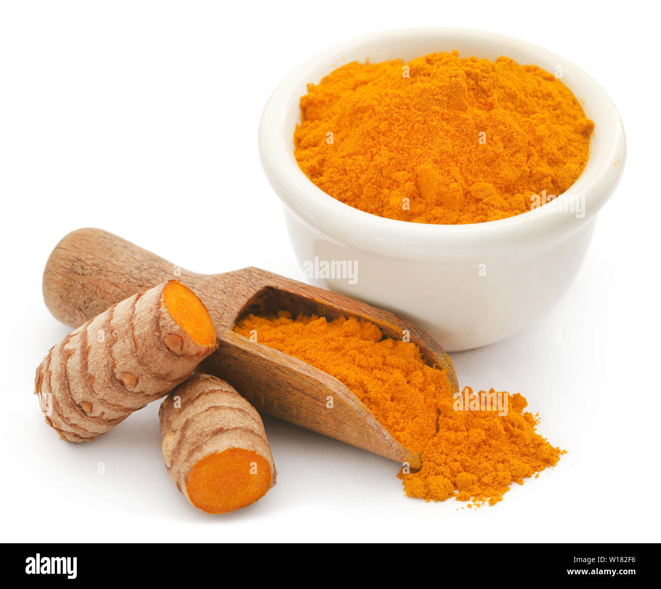 Raw turmeric with powder in small bowl over white background Stock ...
