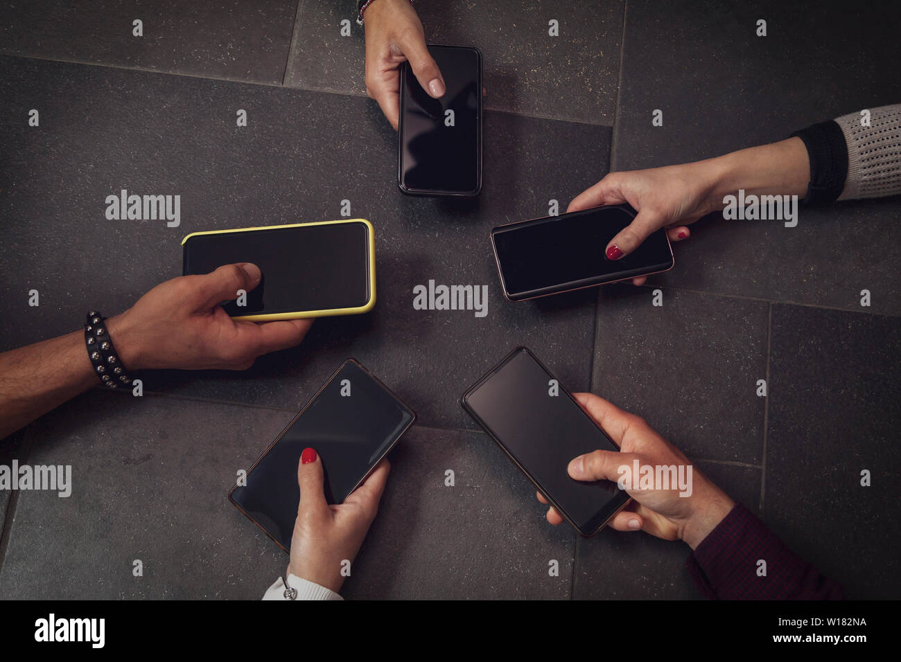 group of people addicted having fun together using smart phones ...