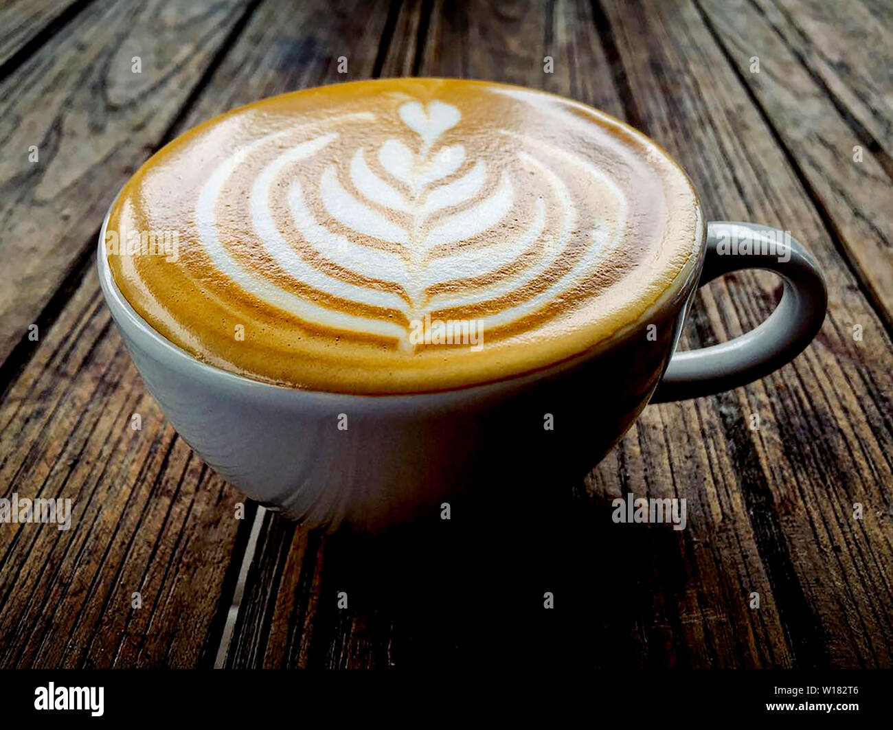 cup of coffee latte on dark wood table, beautiful latte art Stock Photo - Alamy