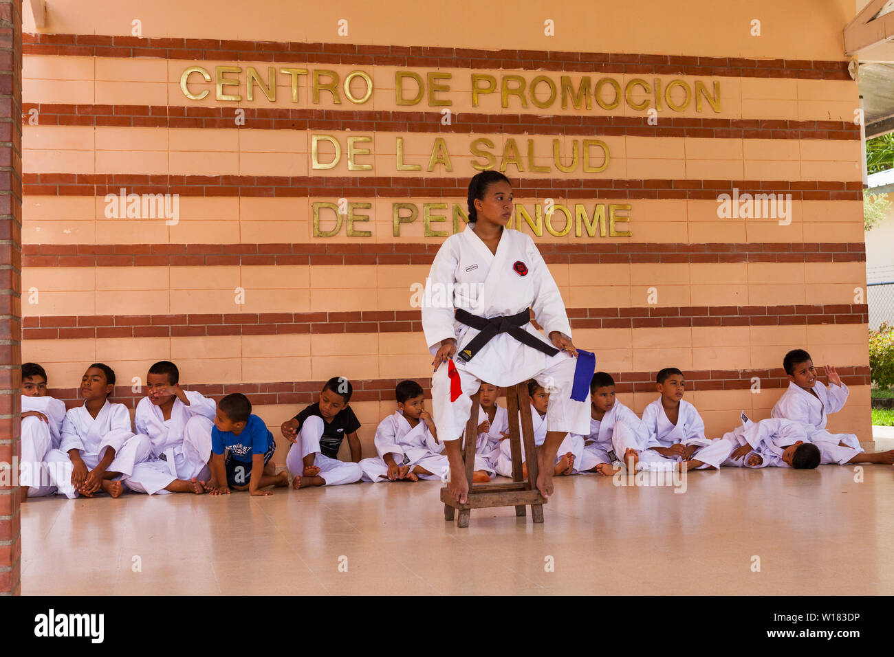 A female black belt is judging a karate competition in Okinawan Gojo ...