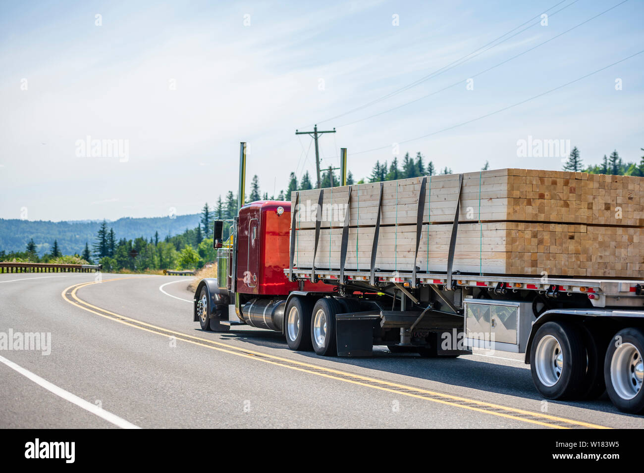 Big rig red classic powerful long haul semi truck with flat bed semi ...