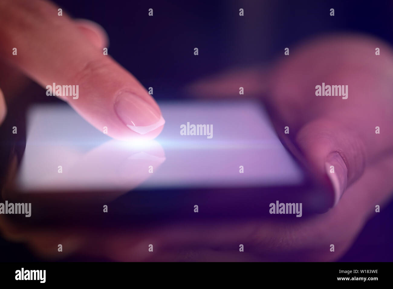 Finger touching phone with dark background with copyspace Stock Photo ...