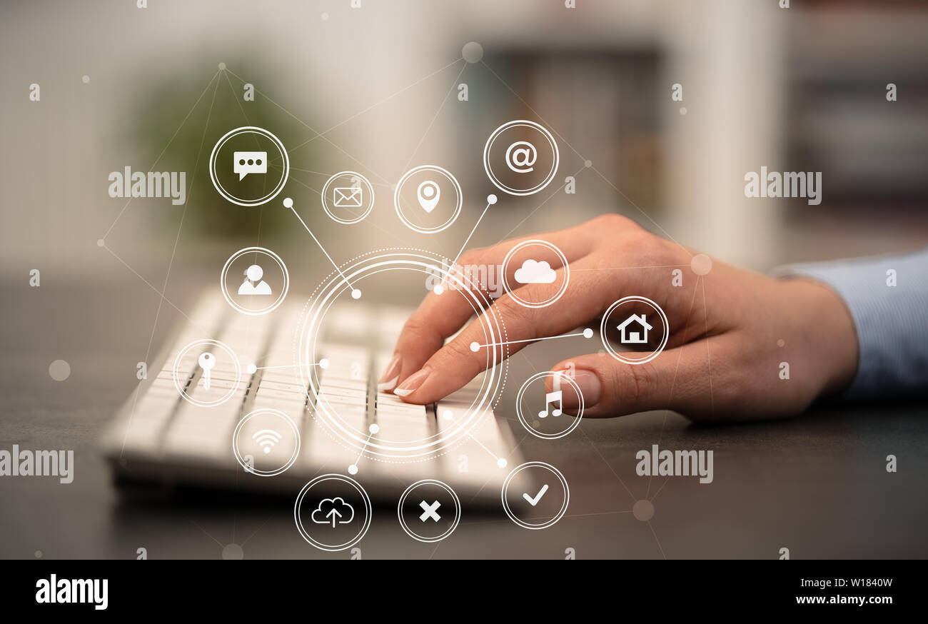 Business woman hand typing on keyboard with application icons around ...