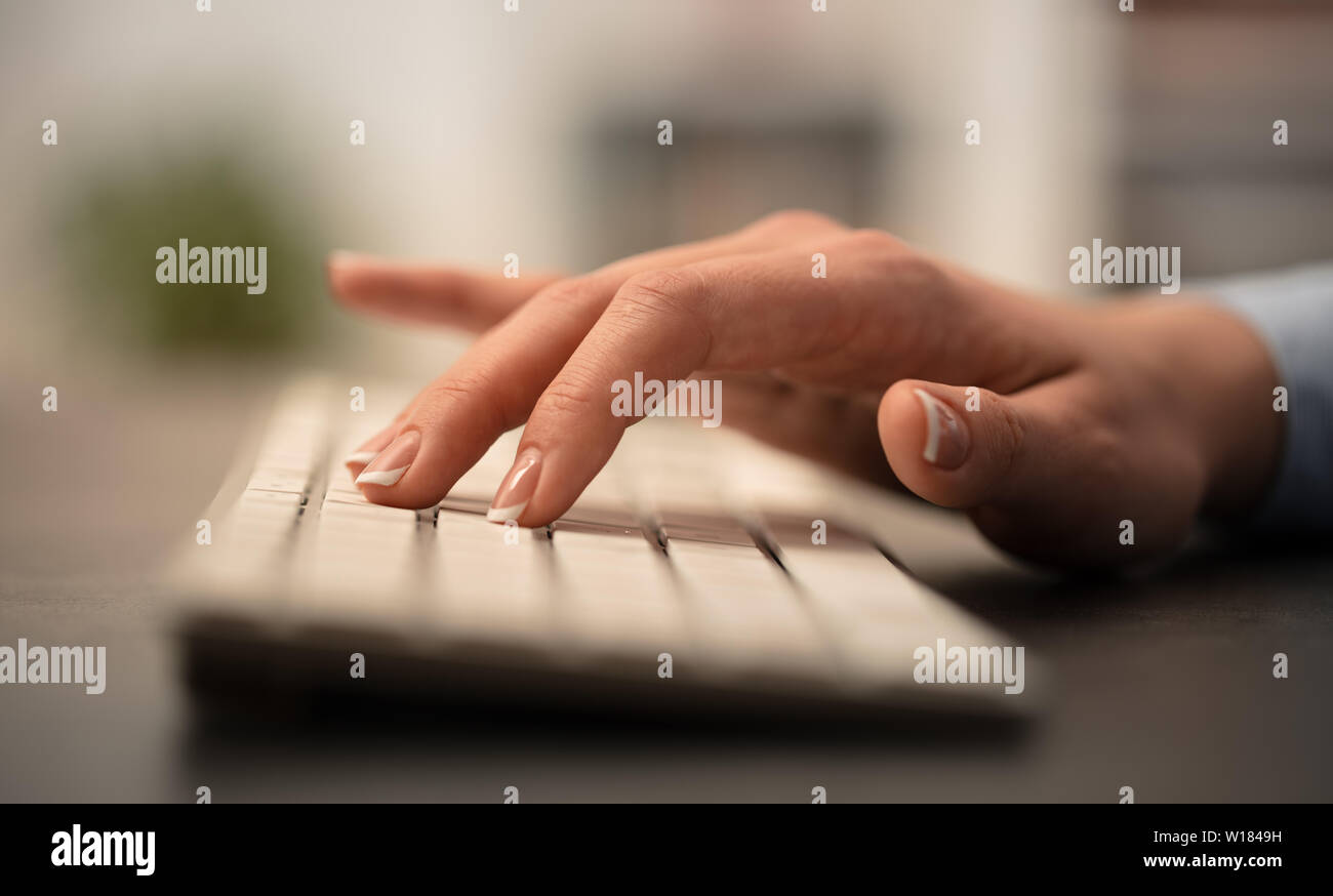 Hand typing on keyboard with office concept Stock Photo - Alamy