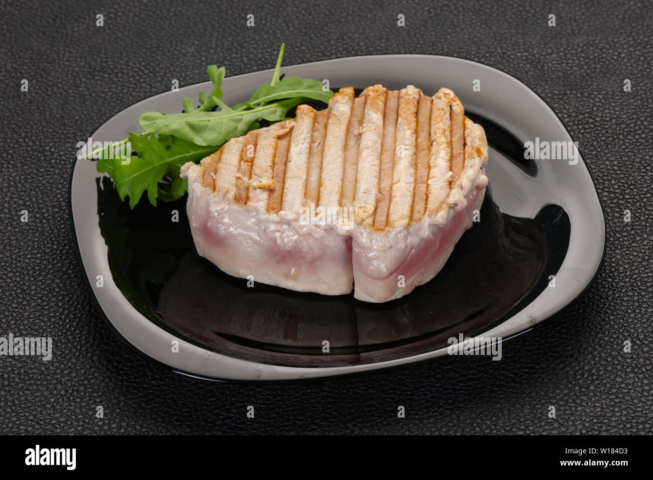 Grilled tuna steak served rocket salad Stock Photo - Alamy