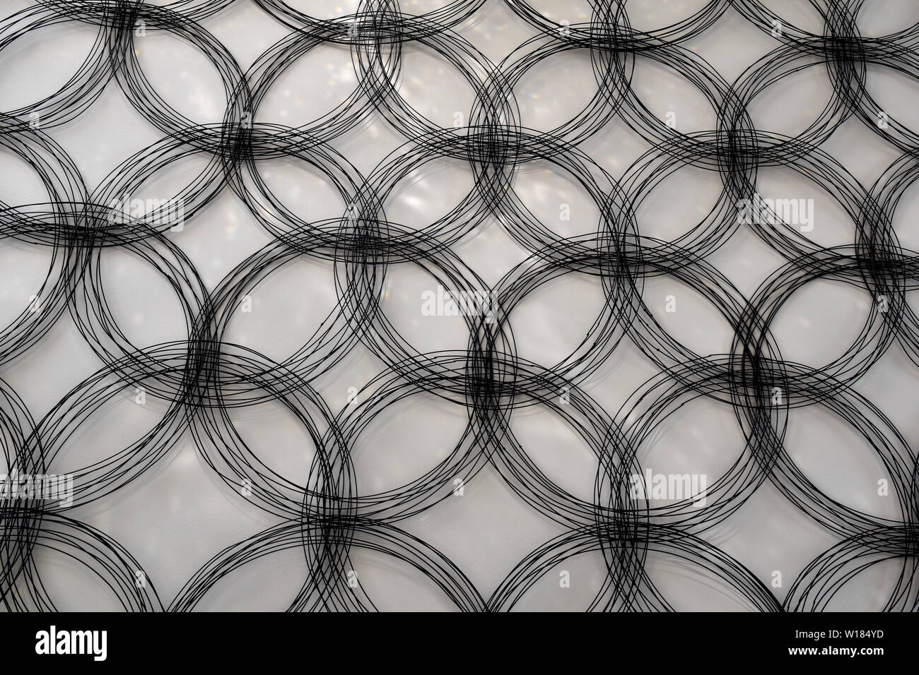 Abstract steel design tri-circle art design against wall. A nice ...