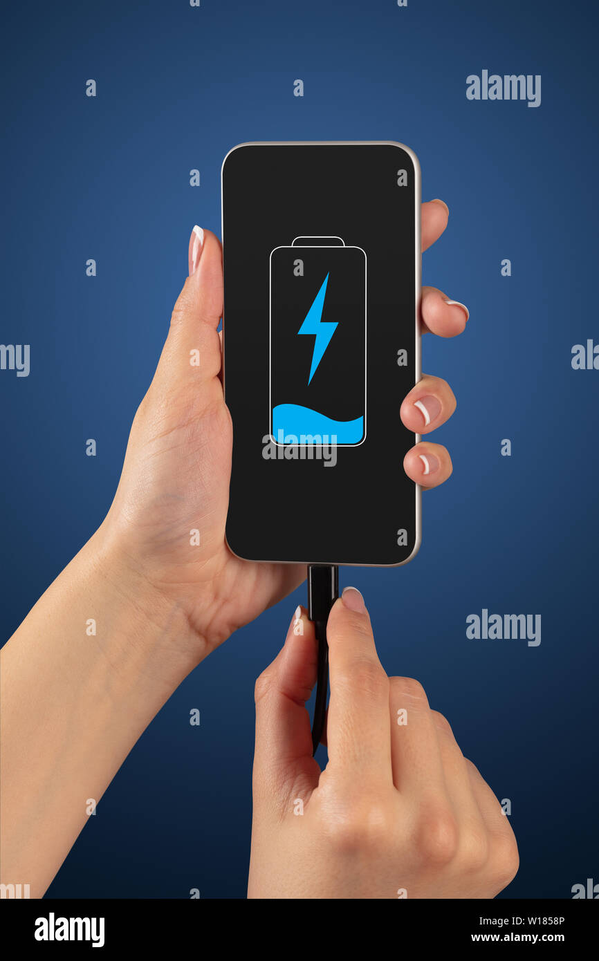 Elegant hand charging cellphone with low battery Stock Photo - Alamy