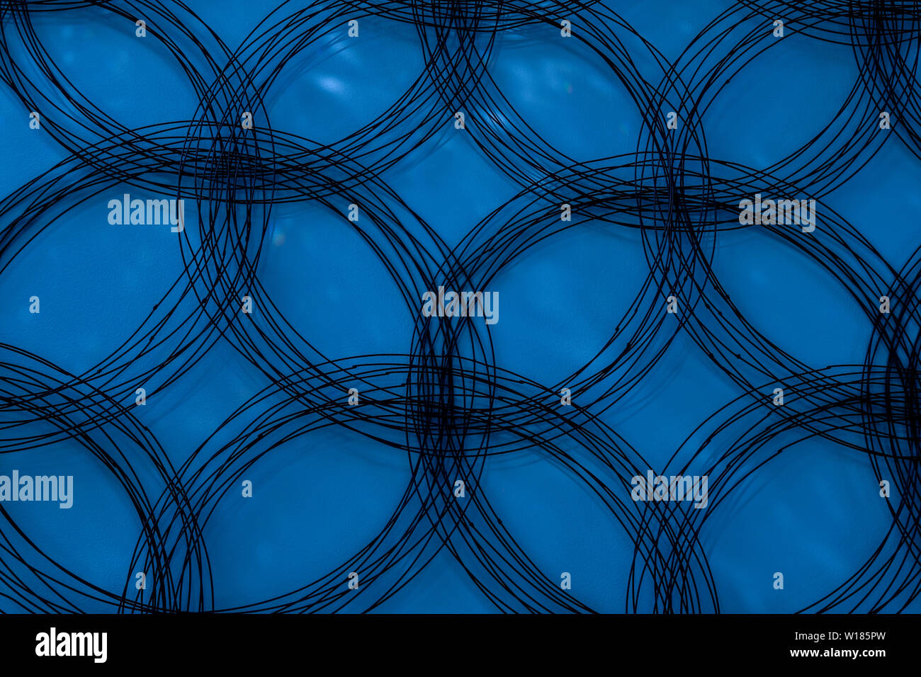 Abstract steel design tri-circle art design against wall. A nice ...