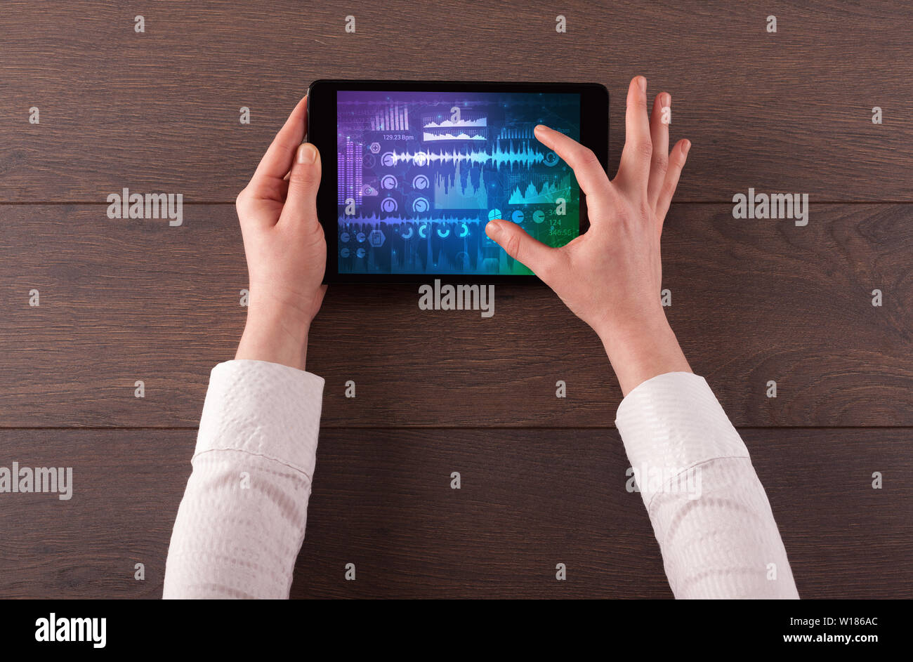 Hand touching tablet with waveforms and sound design concept Stock ...