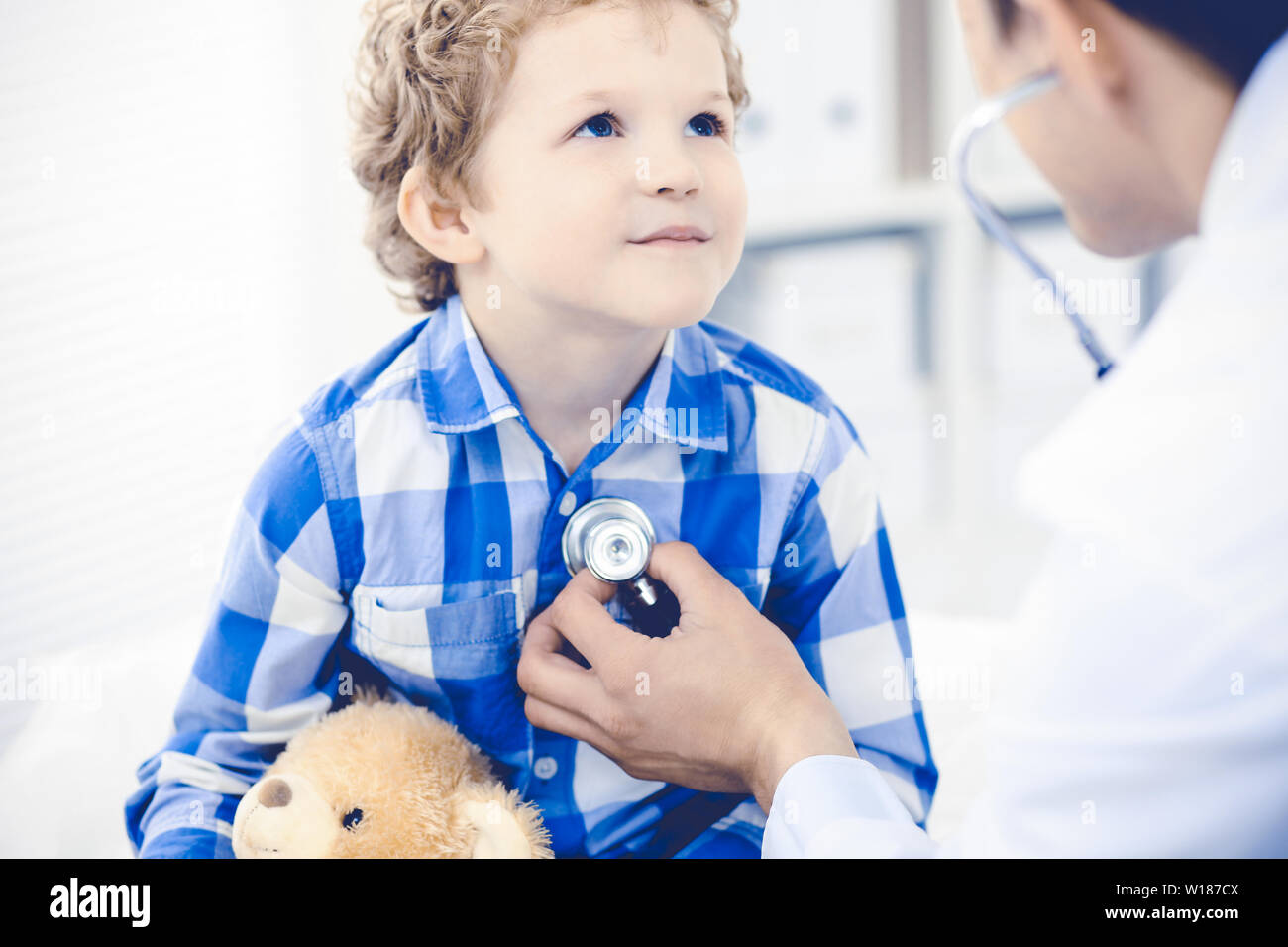 Doctor and patient child. Physician examining little boy. Regular ...