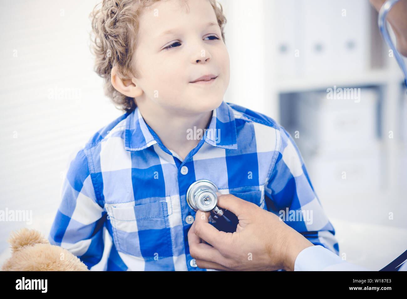 Doctor and patient child. Physician examining little boy. Regular ...