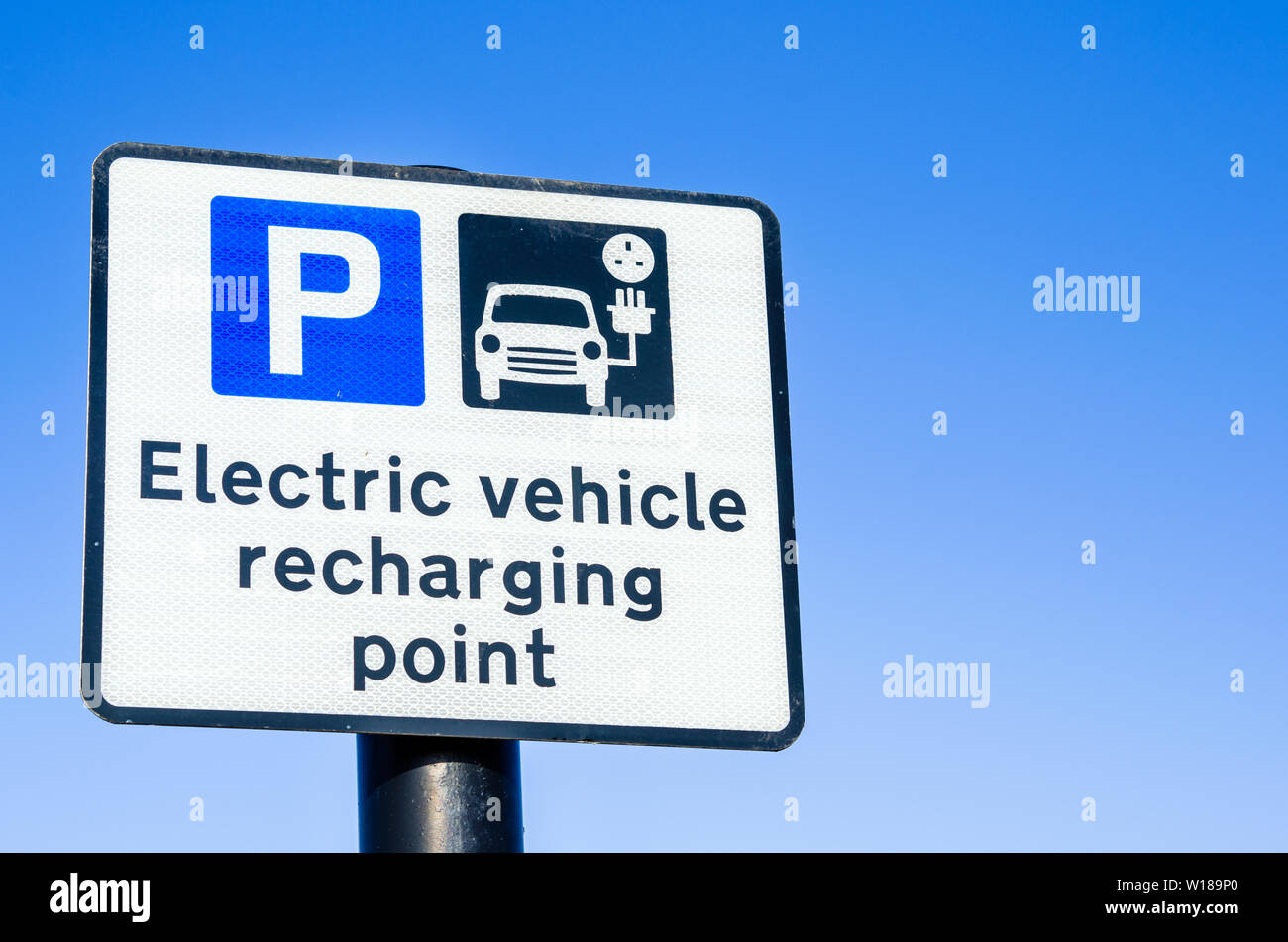 Recharging point for electric car sign against clear sky Stock Photo ...