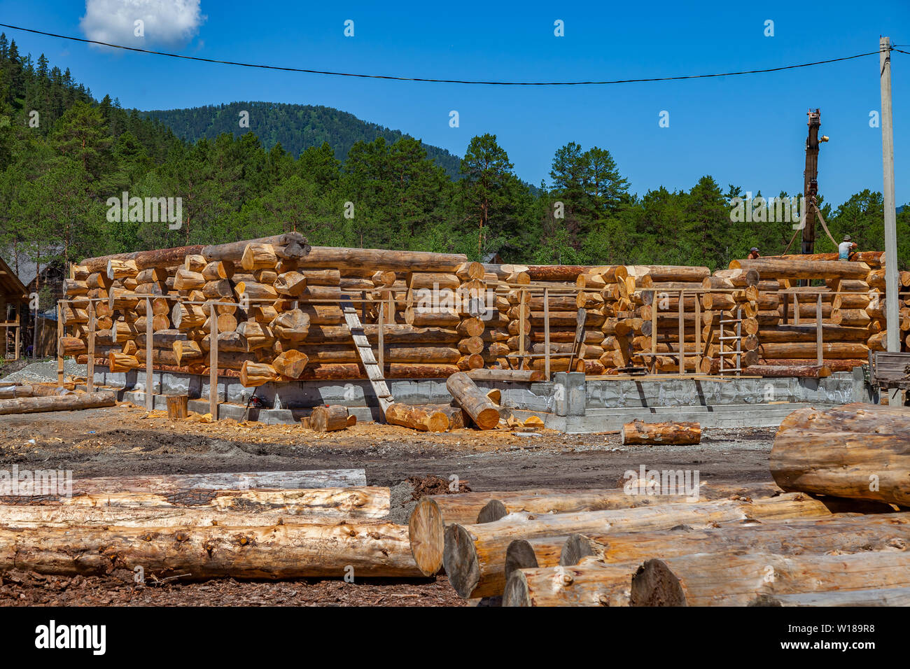 Construction of a large wooden house from a thick round timber cut in ...