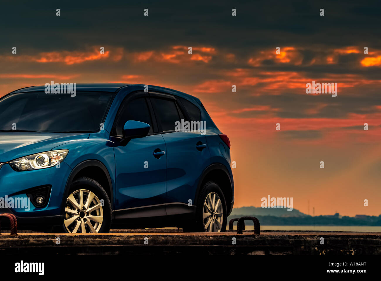 Blue compact SUV car with sport and modern design parked on concrete ...