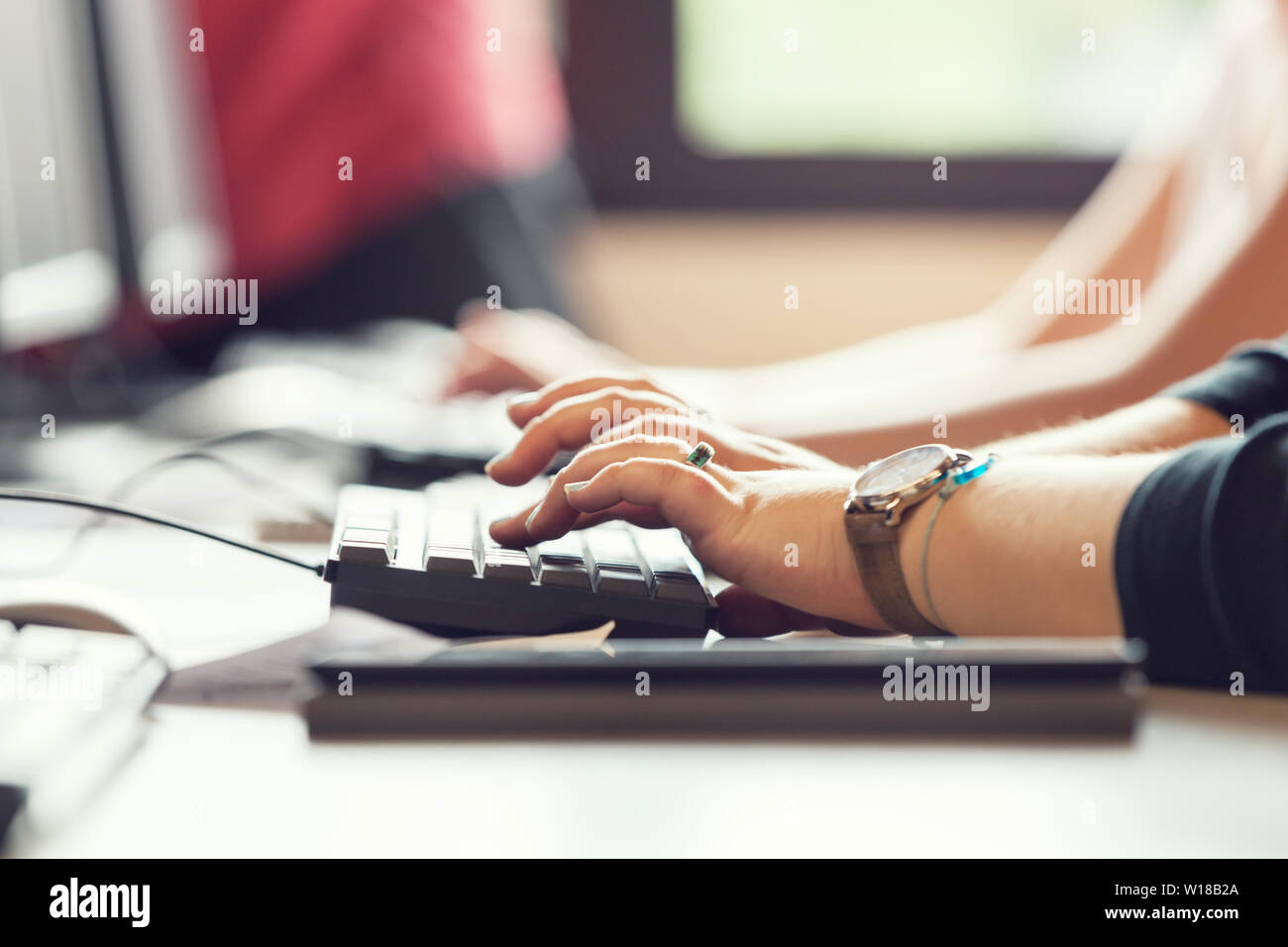 Two typing hands hi-res stock photography and images - Alamy