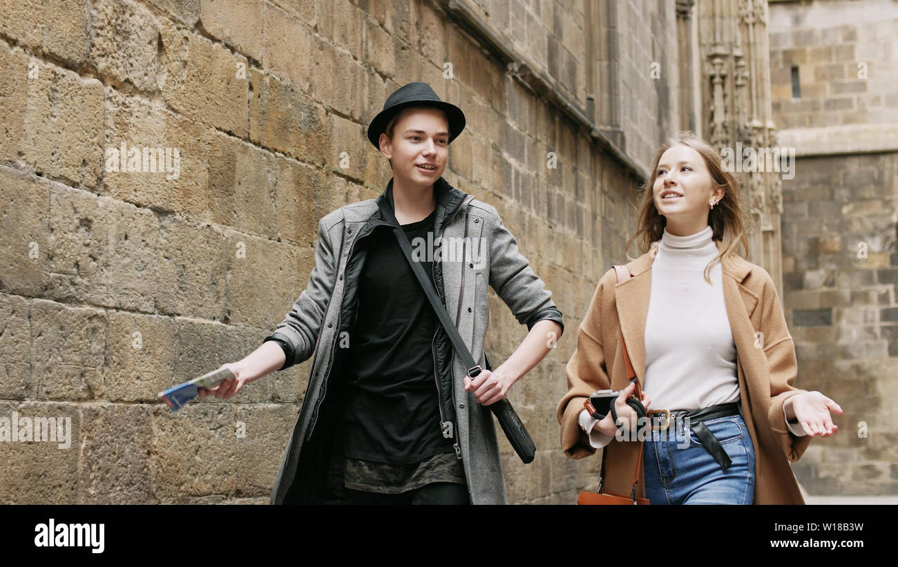 Friends walking together through tight street Stock Photo - Alamy