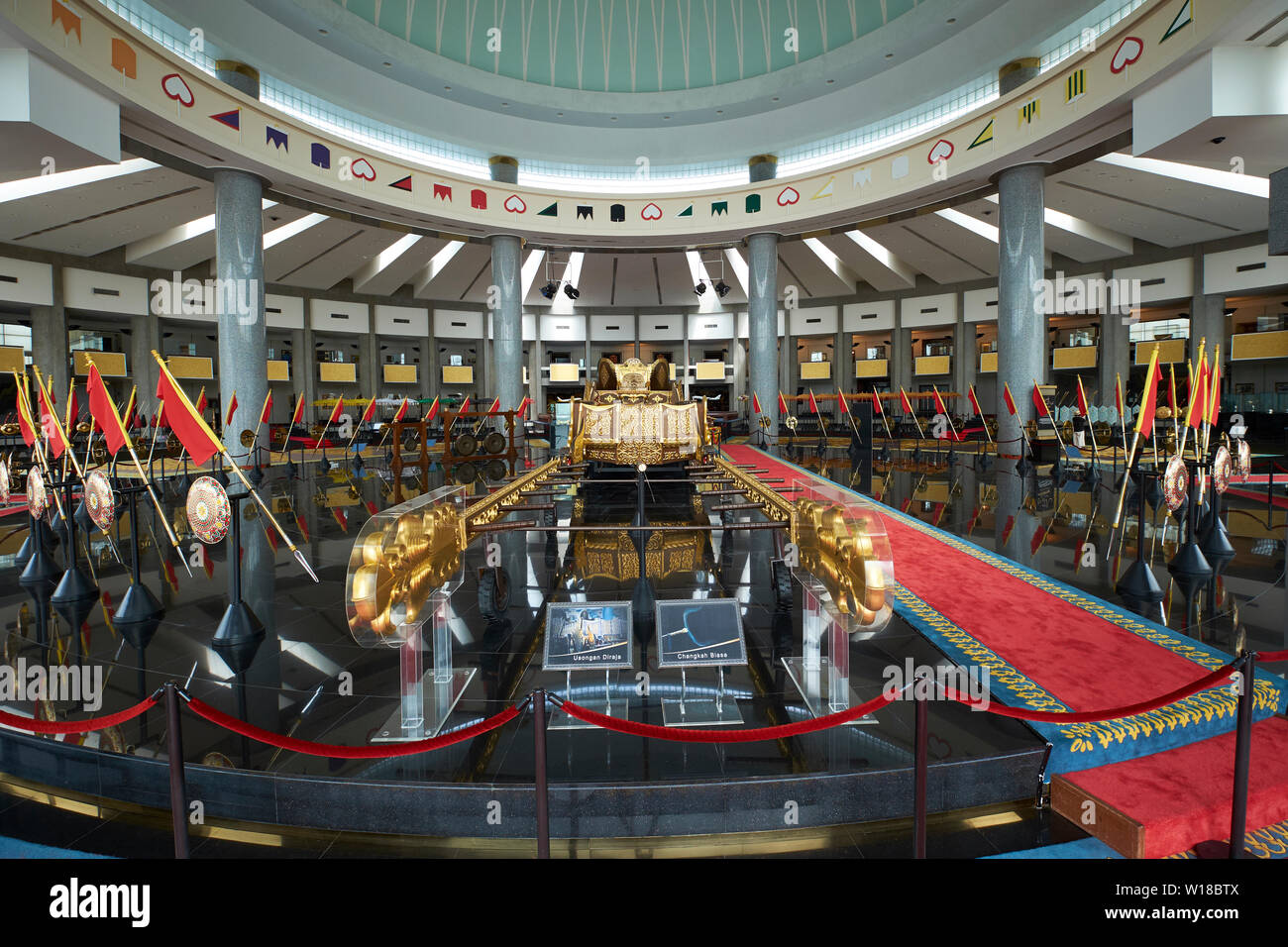 Interior view of the domed Royal Regalia Museum with ornate chariot in ...