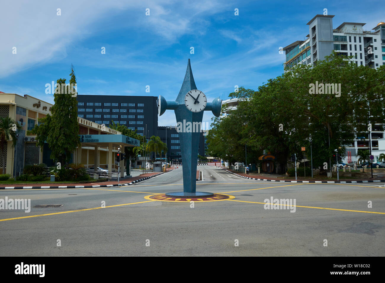Four faced clock in a downtown intersection in Bandar Seri Begawan ...