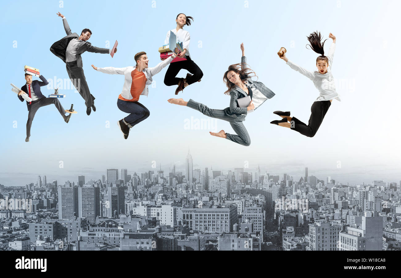 Happy office workers jumping and dancing in casual clothes or suit with ...
