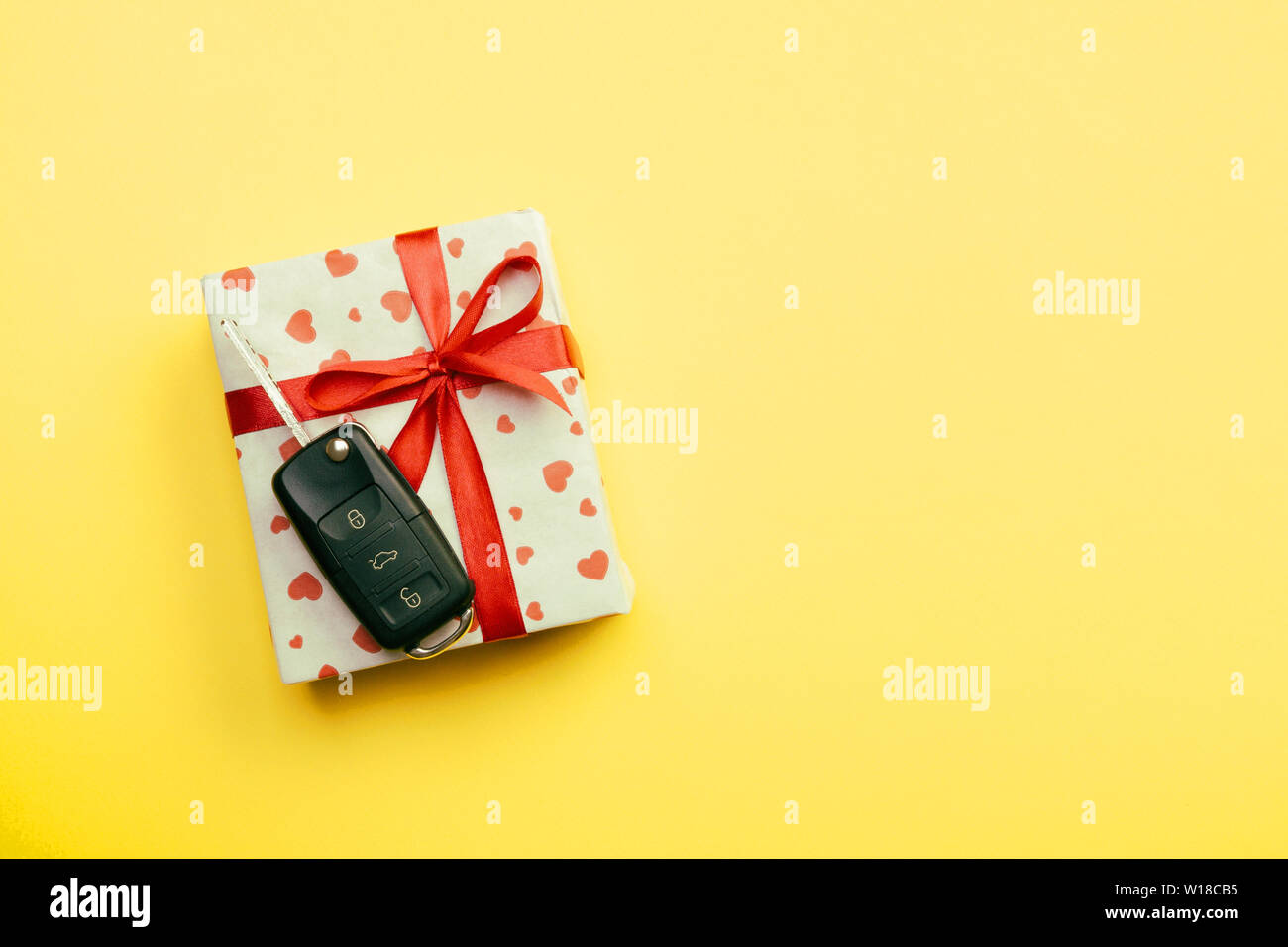 Give gift car key concept top view. Present box with red ribbon bow ...