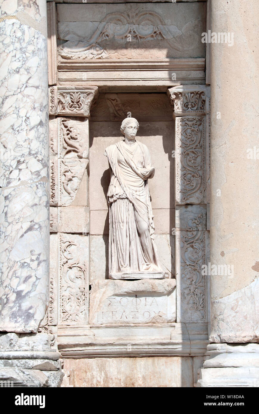 Antique marble female statue on facade of famous Celsus Library in ...