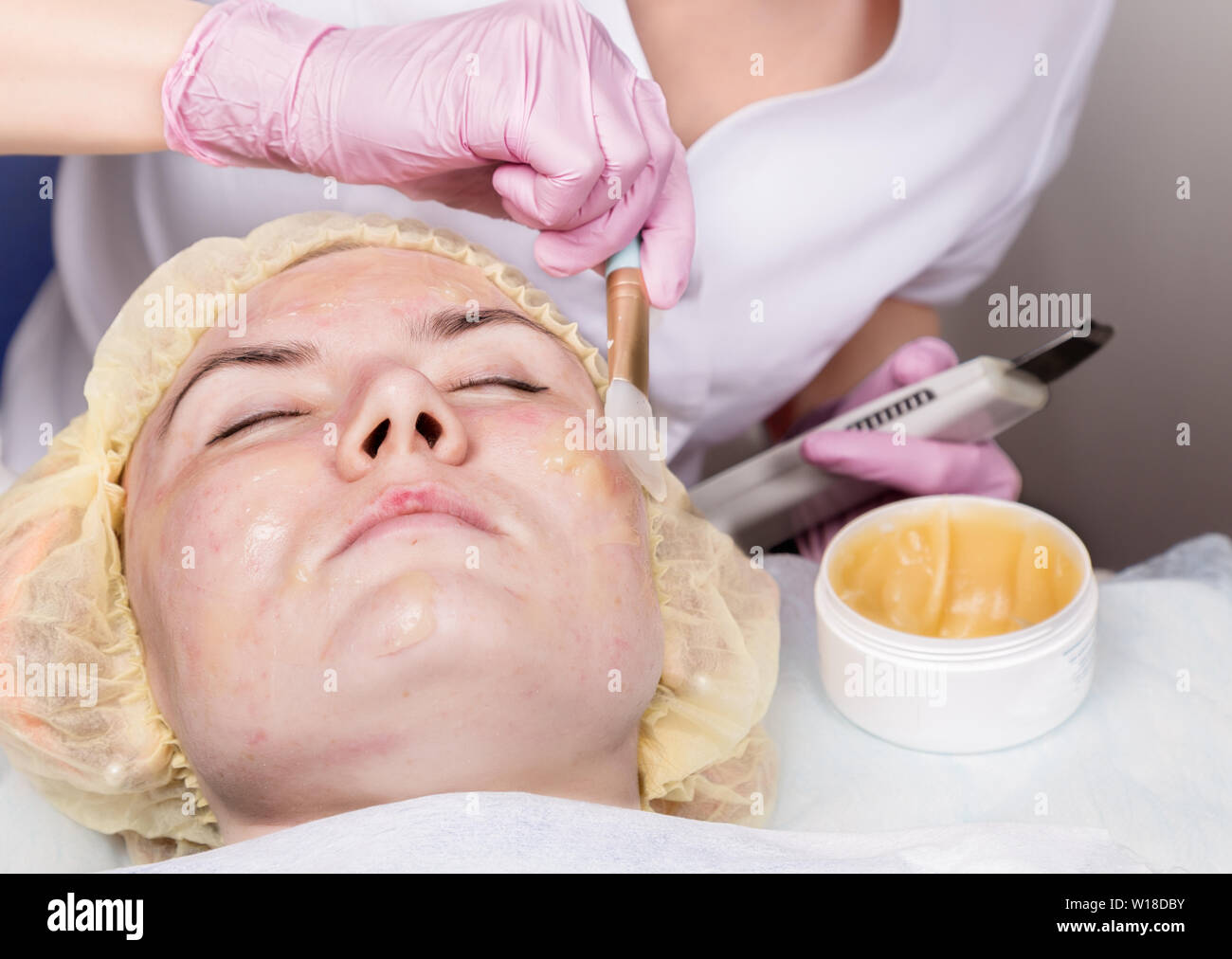 beautician at work. Ultrasonic face cleaning procedure for problem skin ...
