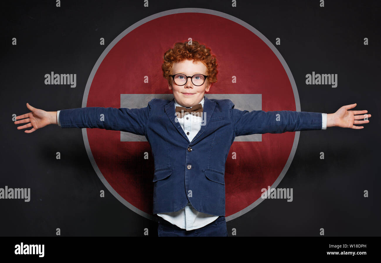 Сhild with stop sign against blackboard background Stock Photo - Alamy