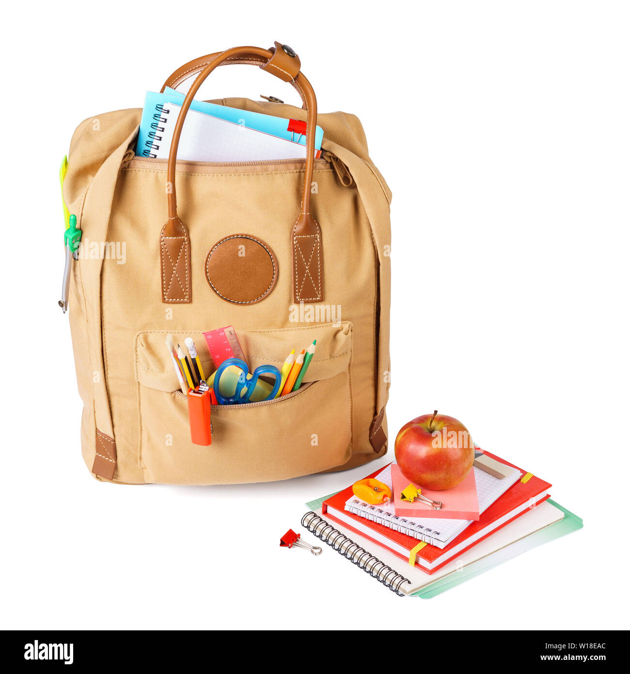 Brown school backpack full of various colorful stationery and supplies ...