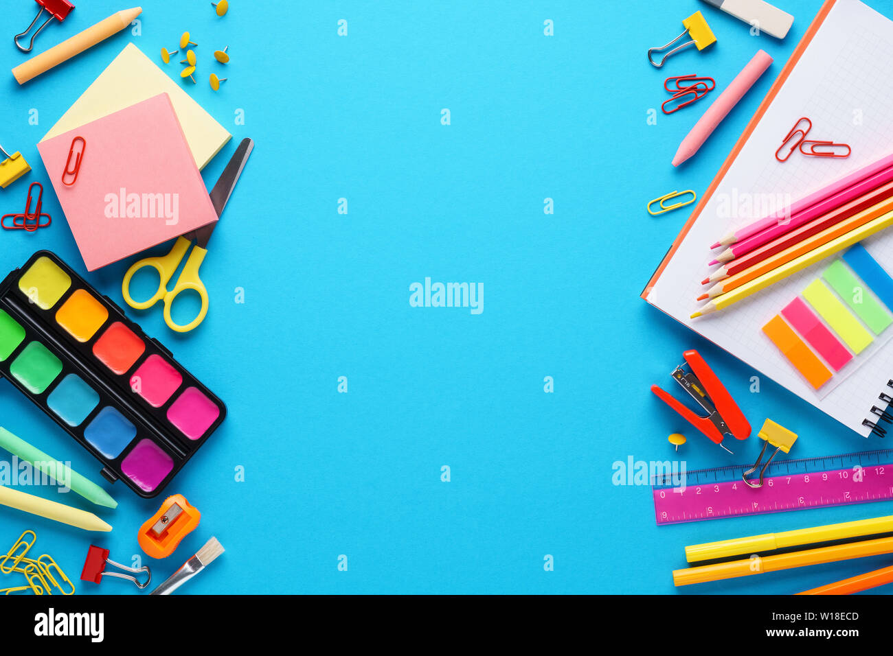 Various colorful stationery on blue background. Back to school frame ...