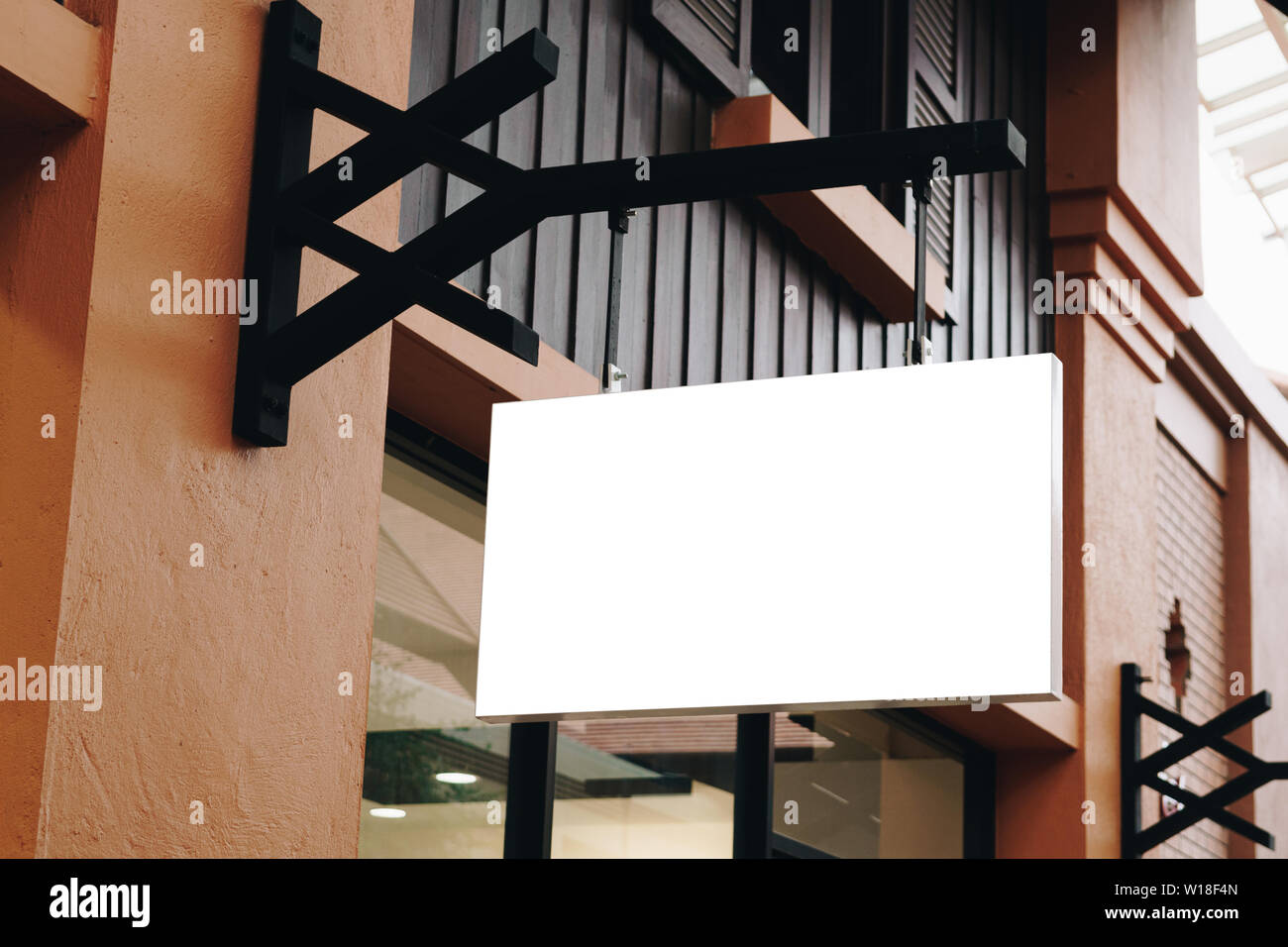 Empty signage and blank mock up hanging on street with copy space Stock ...