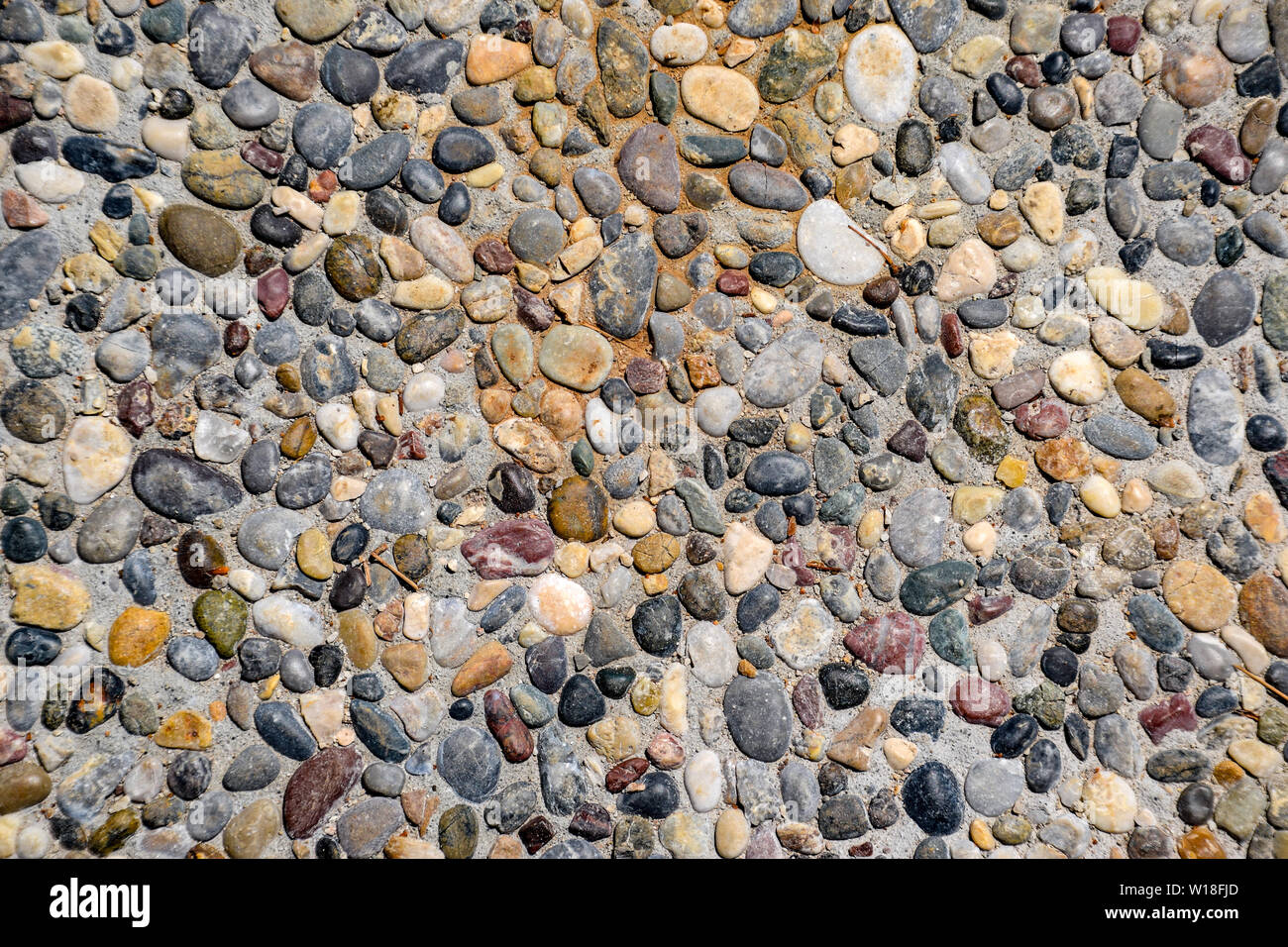 Background texture of the pavement of stone pellets. Pebbles in ...