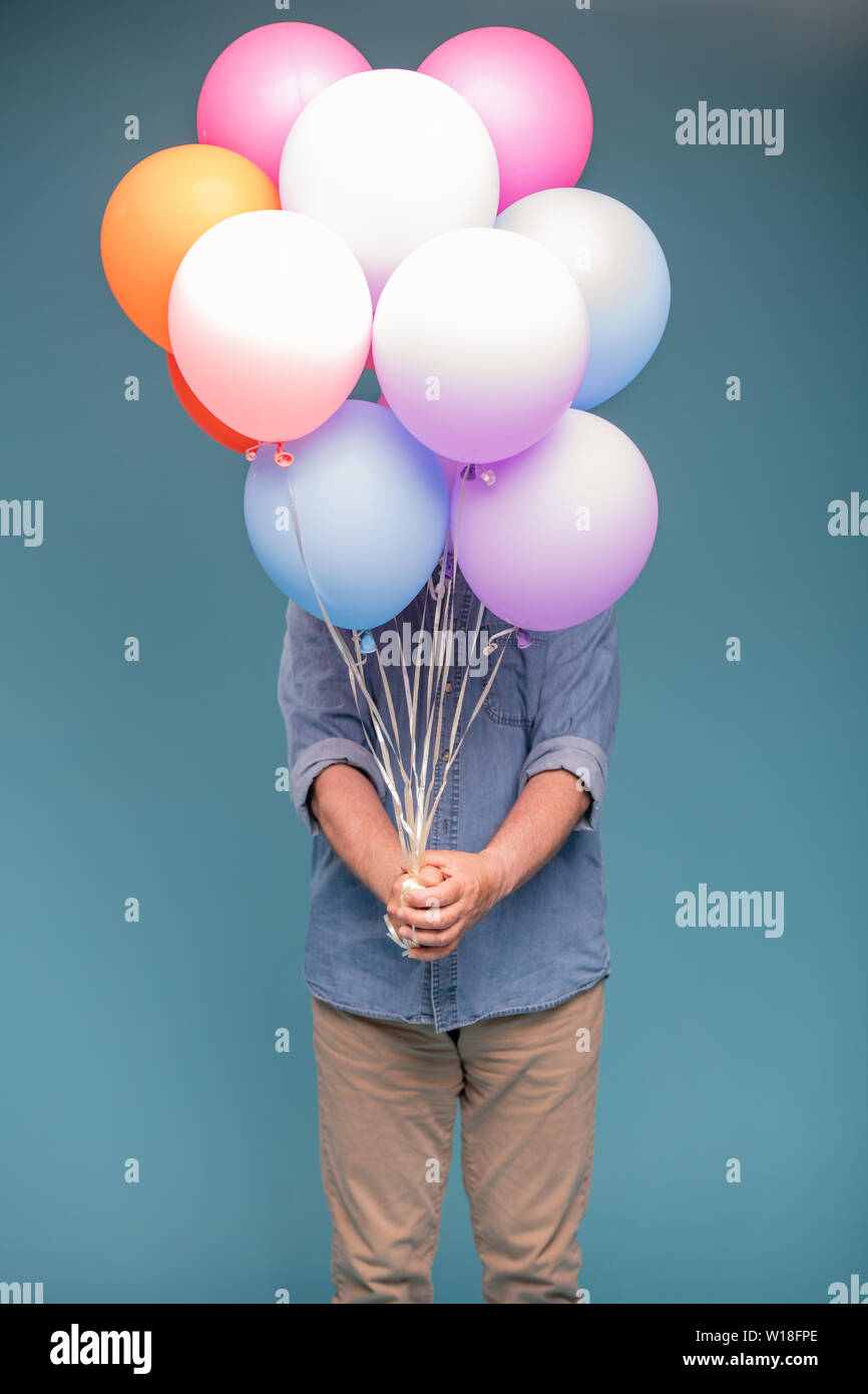 Standing man with balloons hi-res stock photography and images - Alamy