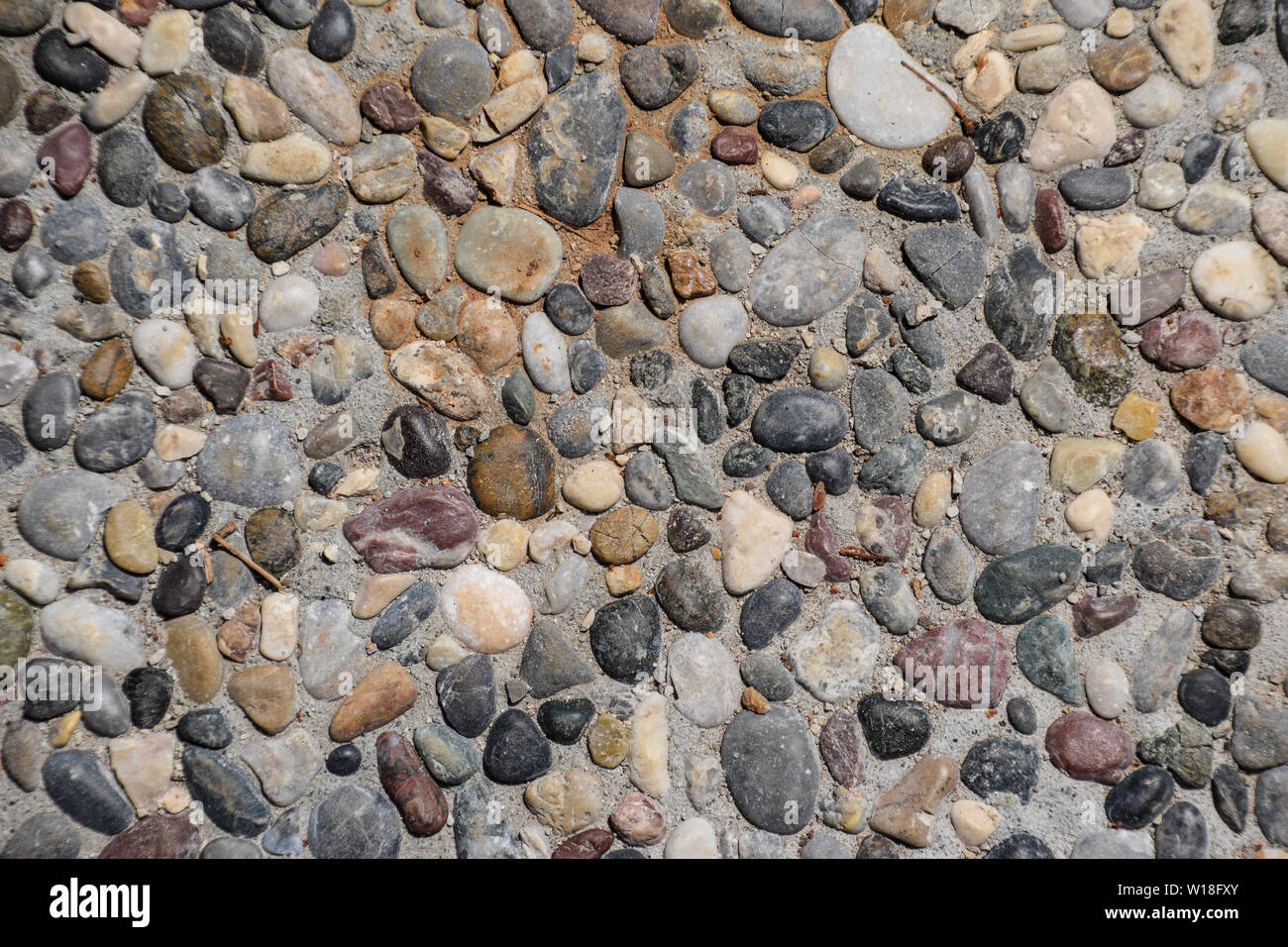 Background texture of the pavement of stone pellets. Pebbles in ...