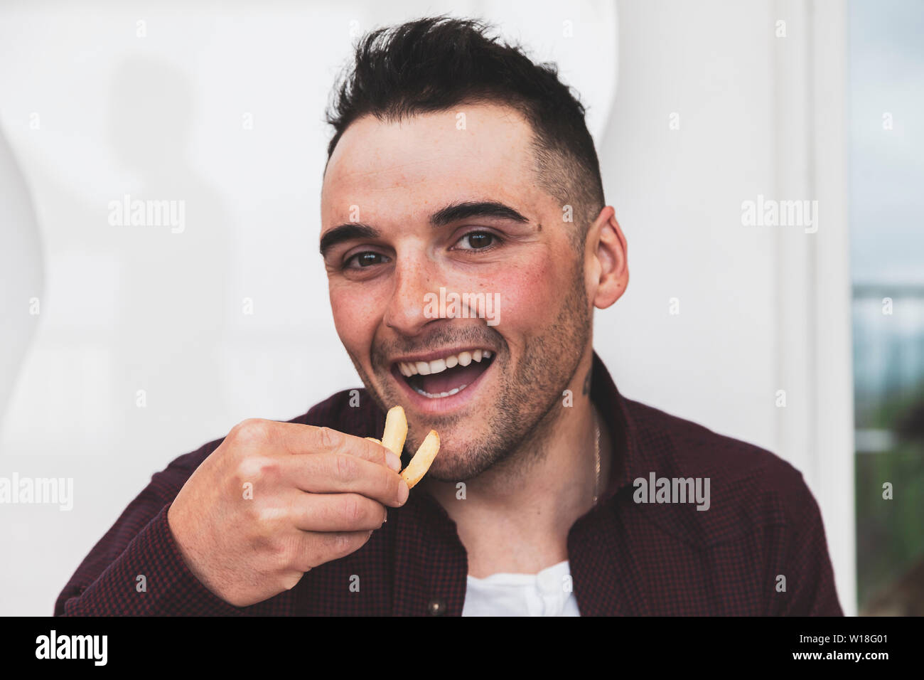 Eating french fries face hi-res stock photography and images - Alamy