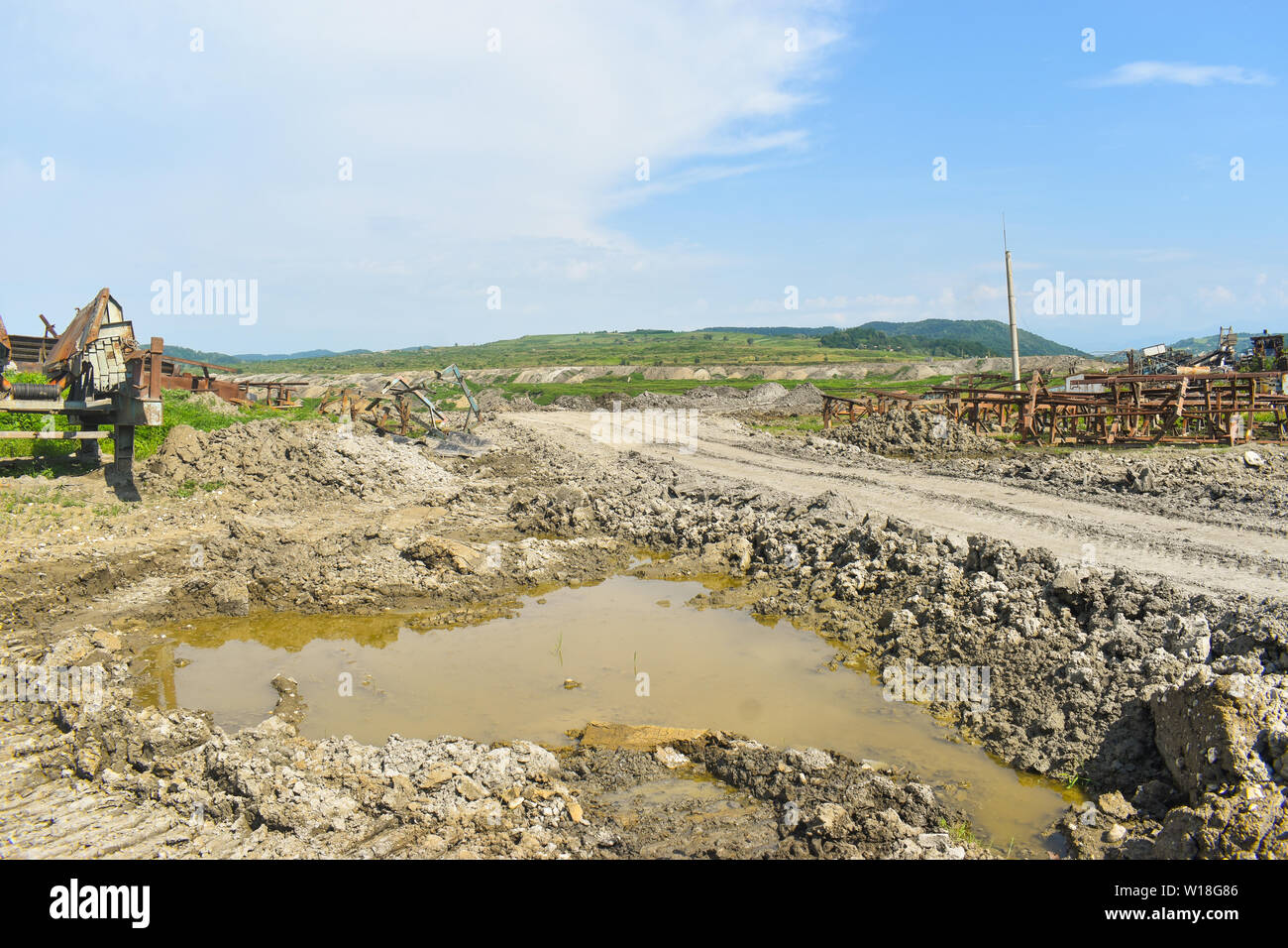 Huge open pit coal mine made with big excavators, loaders, trucks and ...