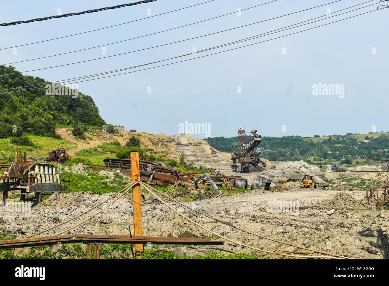 Huge open pit coal mine made with big excavators, loaders, trucks and ...