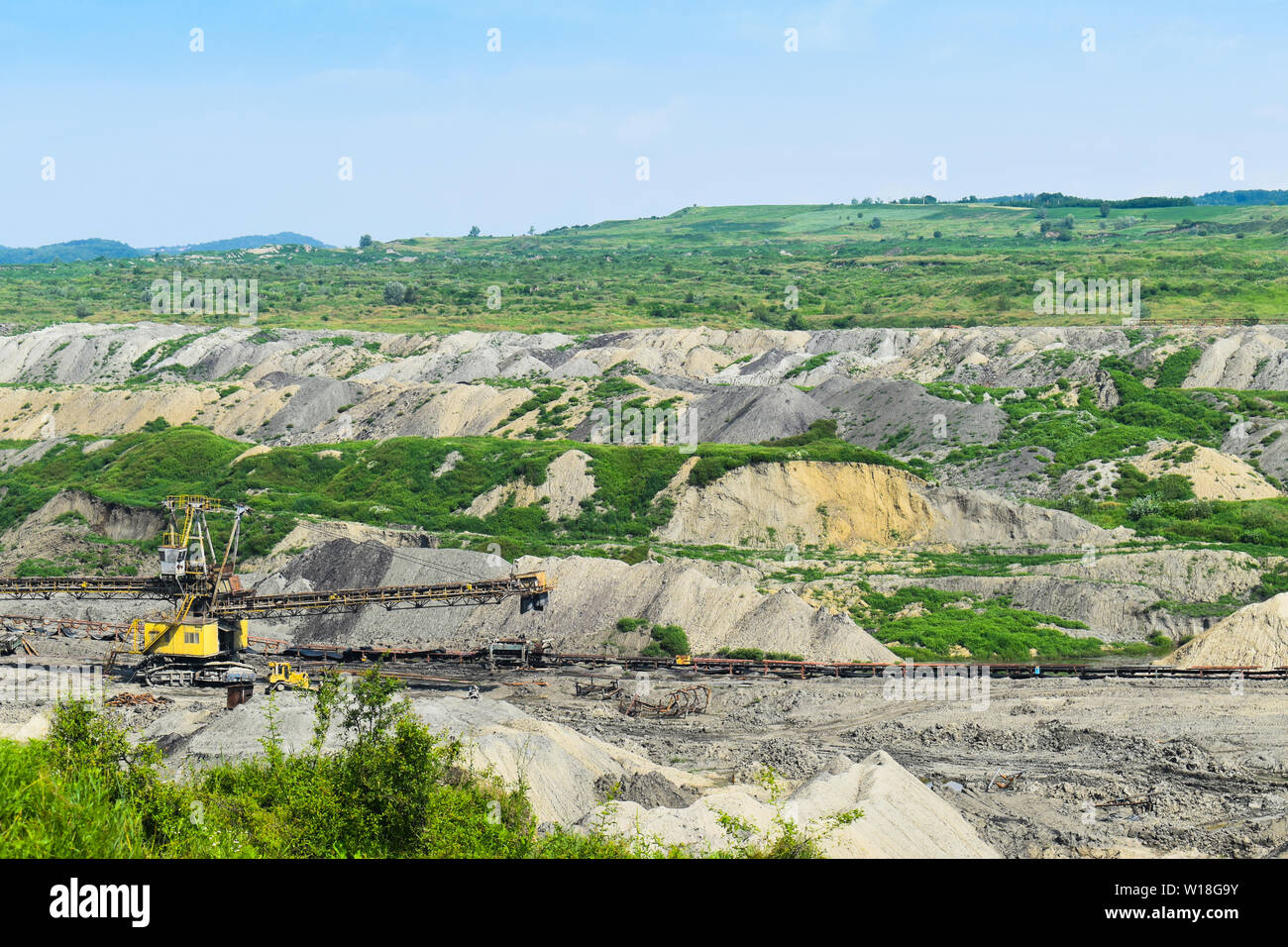 Huge open pit coal mine made with big excavators, loaders, trucks and ...