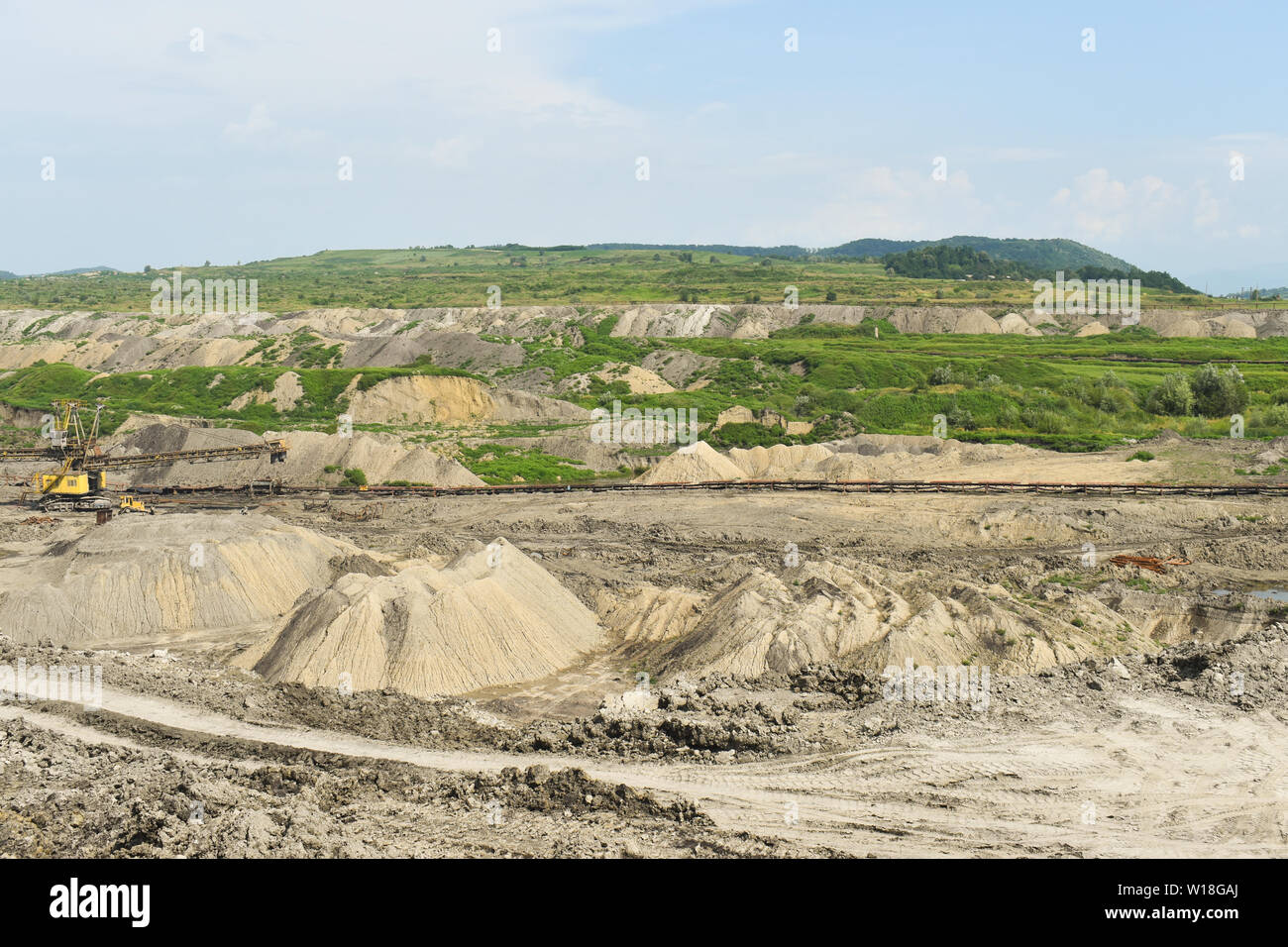 Huge open pit coal mine made with big excavators, loaders, trucks and ...